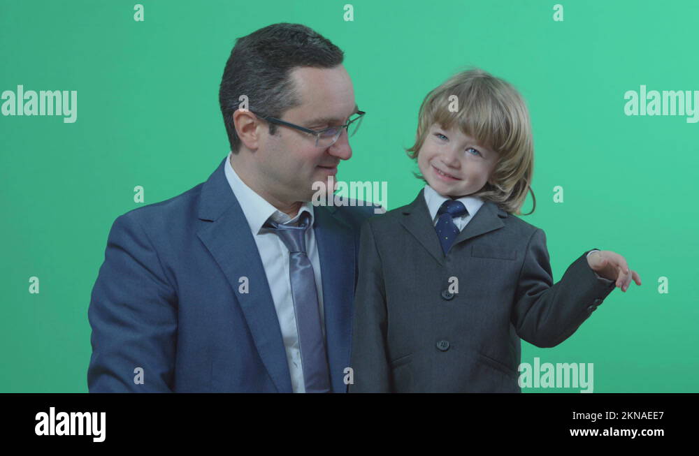 Funny man and child with suit and tie show muscle, green screen Stock ...