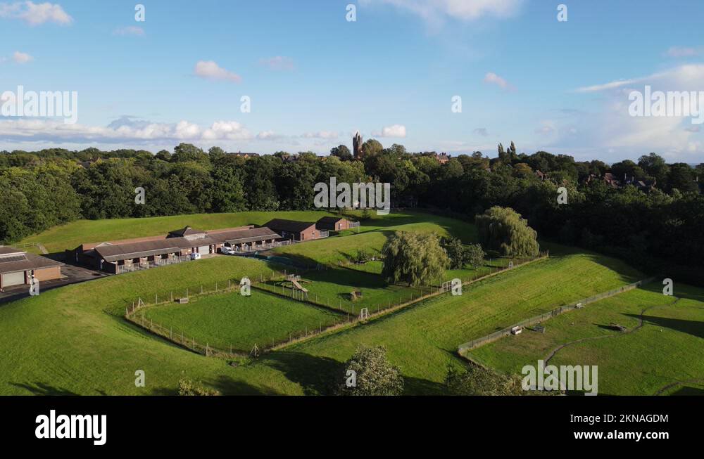 Parks and meadows, historic red brick buildings with several towers ...