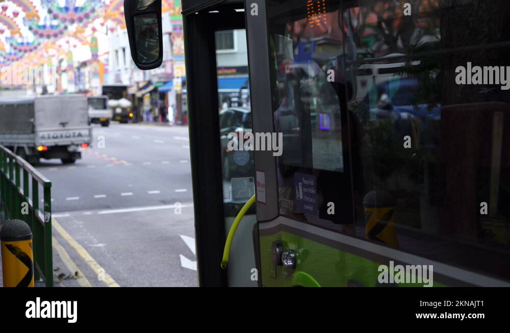 Bus door closing. Public transport in Little India, Singapore. Close up ...