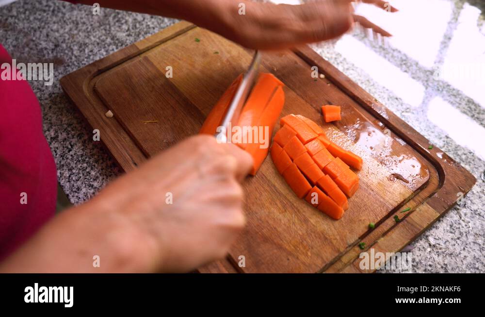 Cutting Peeled Carrot Vertically With A Sharp Knife. close up Stock ...