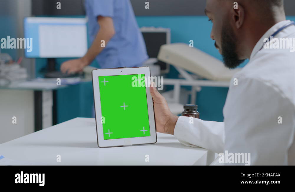 African american specialist doctor looking at mock up green screen ...
