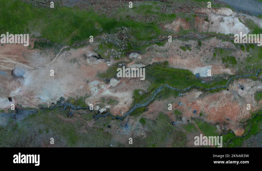 Overhead aerial view of geothermal area in Iceland with smoking ...
