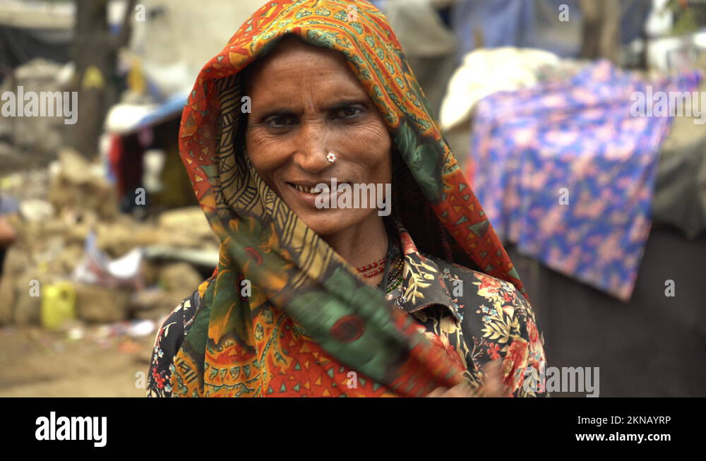 A Poor Indian woman with plastic hut background, Palghar, India Stock ...