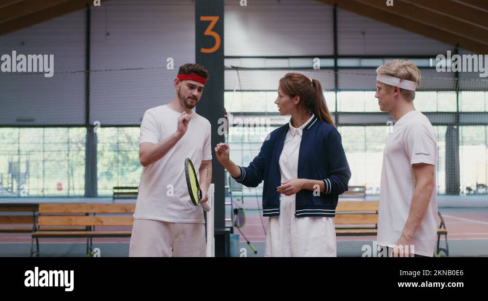 Two men are about to play a tennis, the referee starts by tossing coin ...