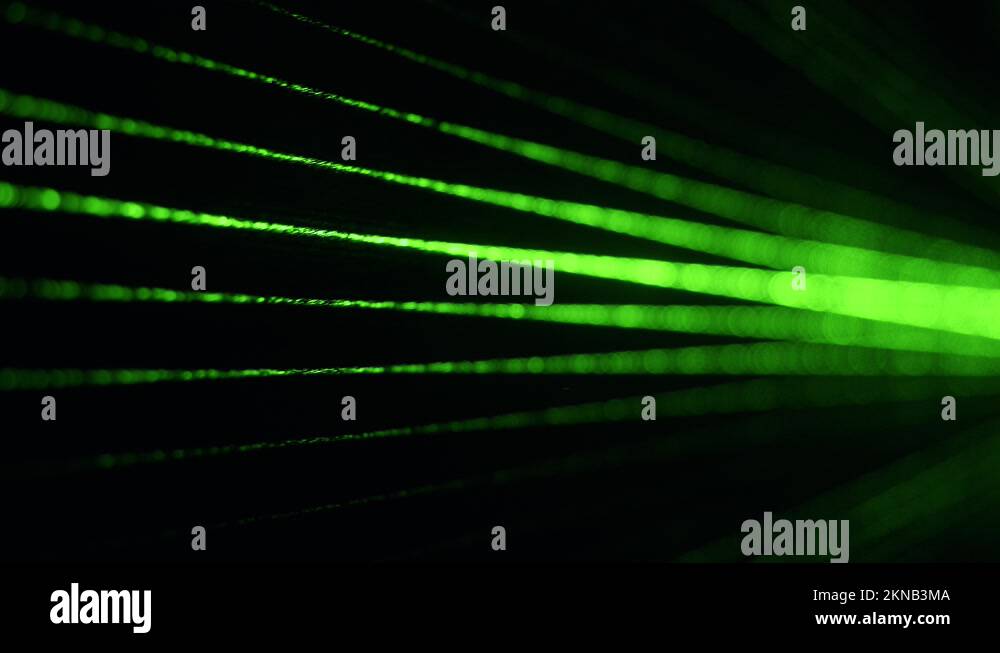 Dust particles in green laser light beam from diffraction grating Stock ...