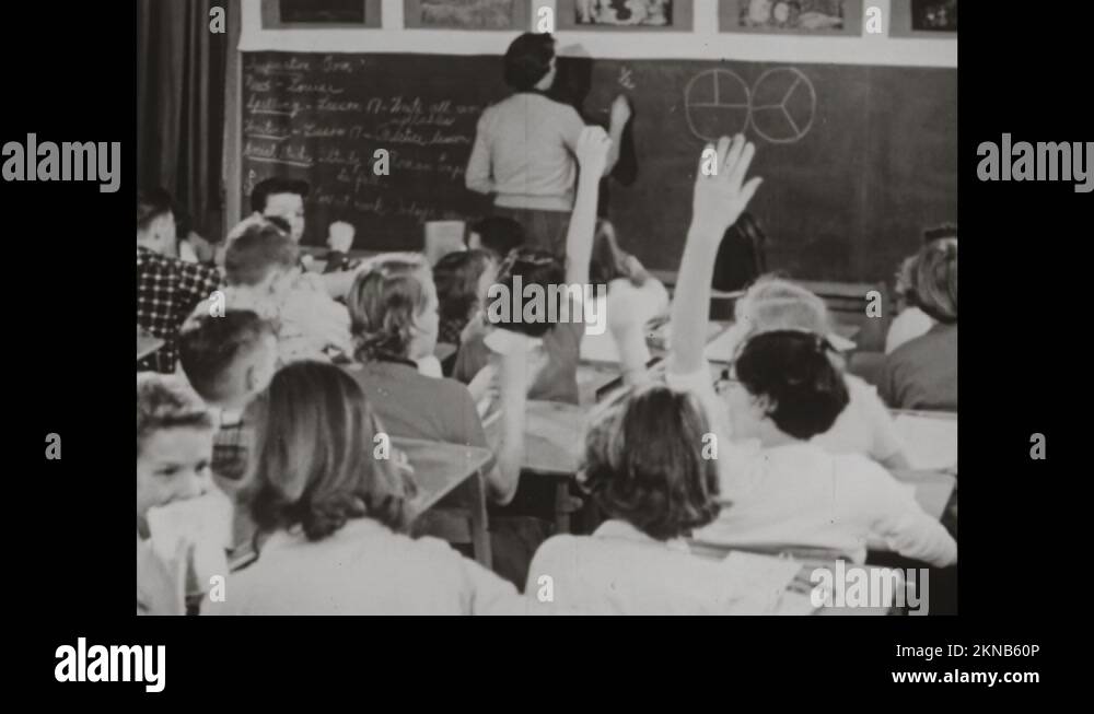 1950s: Classroom in the library. Woman looking into classroom. Crowded ...