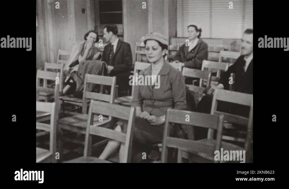 1950s: A small group of adults sitting and listening, woman thinking ...