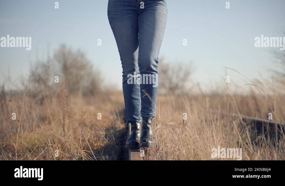 Legs Walking On Railway. Woman Feet In Jeans Walking On Rail Road Rails ...