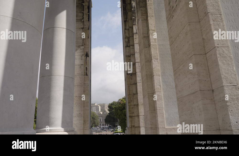 Massive white columns in downtown of Genoa, camera tilting up view ...