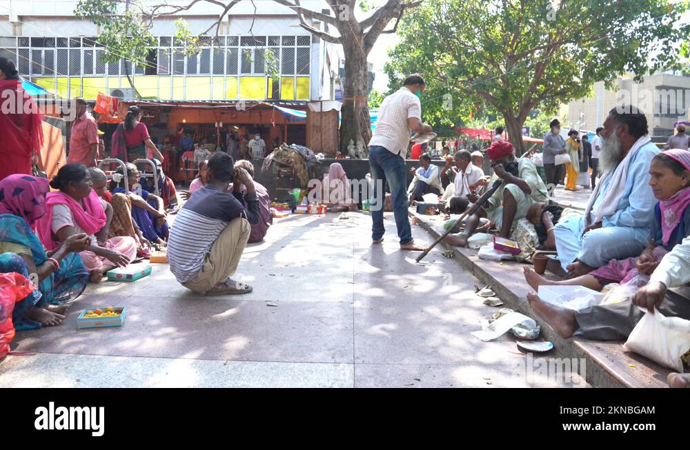 Static shot people distributing prasad to beggars outside Hanuman ...