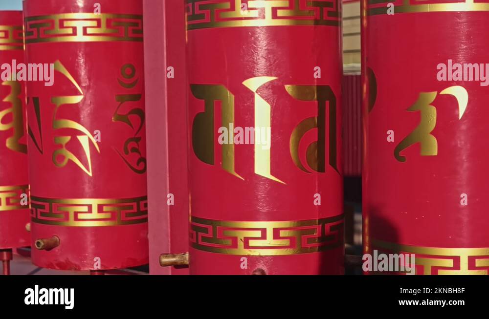 Beautiful Tibetan prayer wheels of red color. Tibetan buddhist praying ...