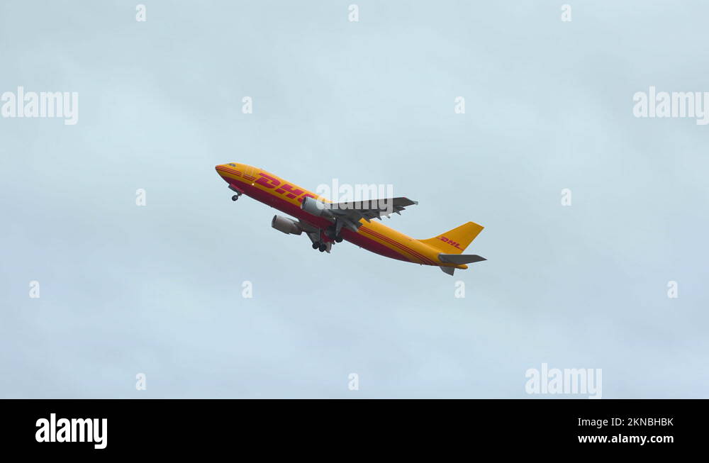 dhl cargo airplane airbus a300 steep climb side view panning left slow ...