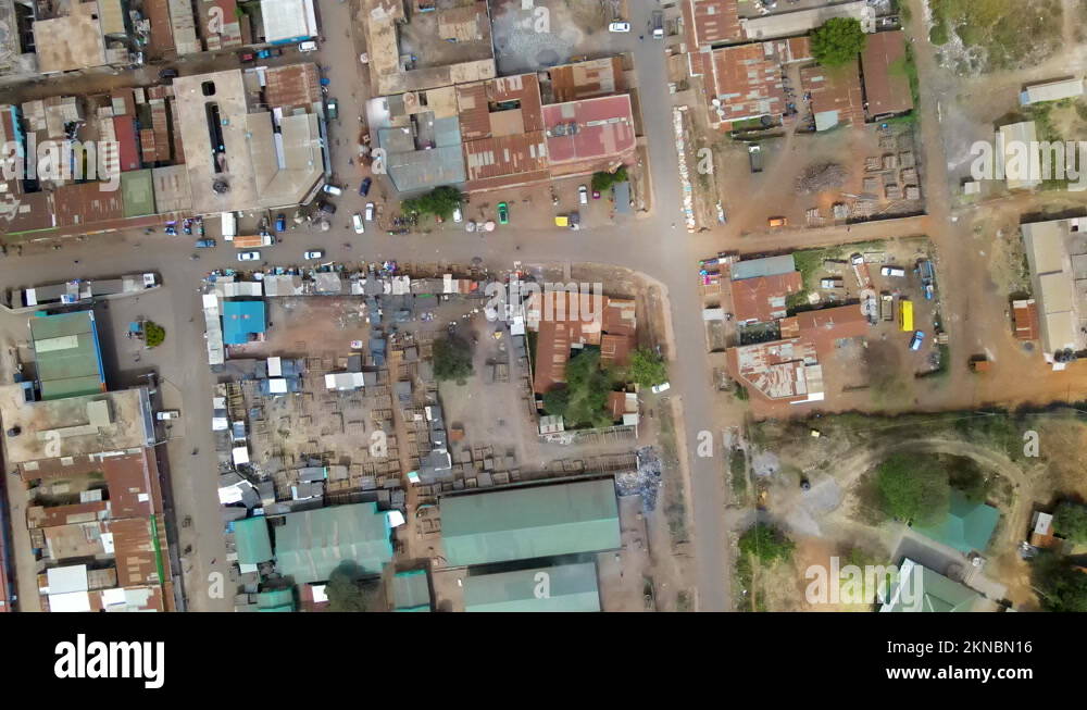 Top down view of small, busy streets in a Kenyan town - drone rising up ...