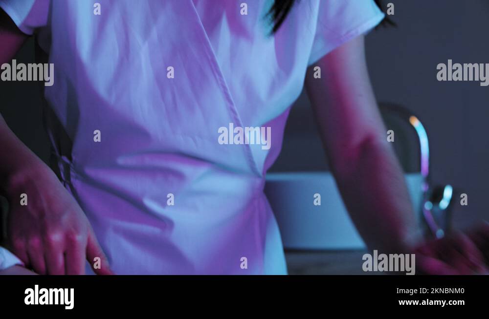 Massage session in neon lighting - therapist pushing on skin on the ...