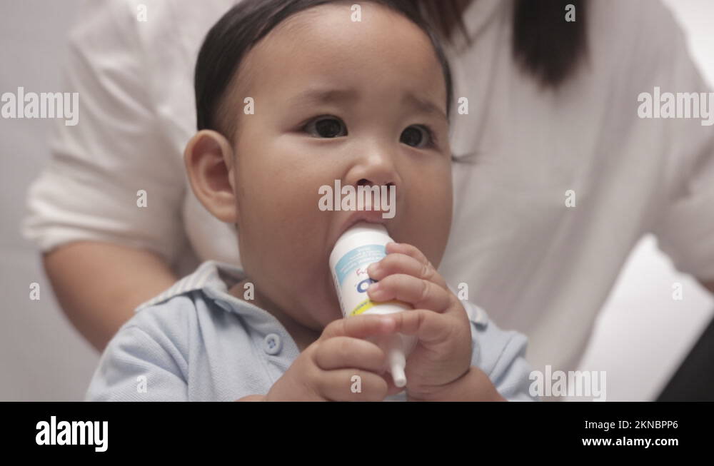 Cute Baby Boy With Chubby Cheeks Playing With White Plastic Bottle ...