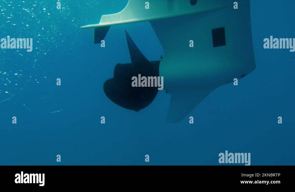 Underwater pov of boat propeller spinning underwater producing air ...