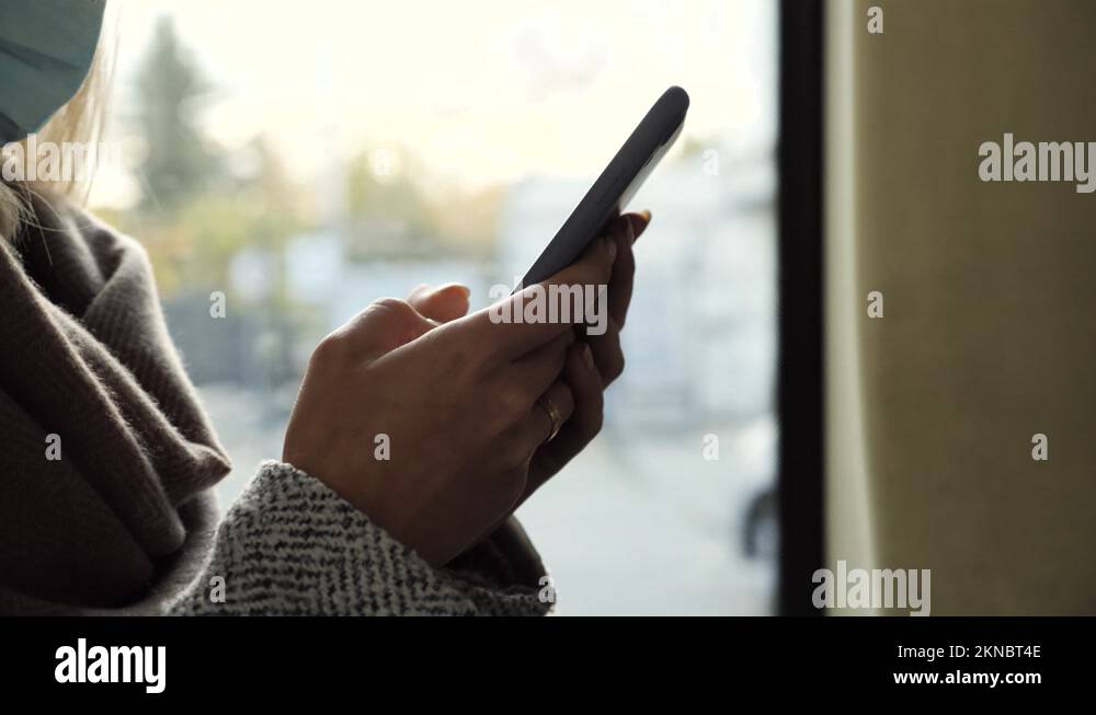 Female hands with smartphone in tram read messages scrolling screen ...
