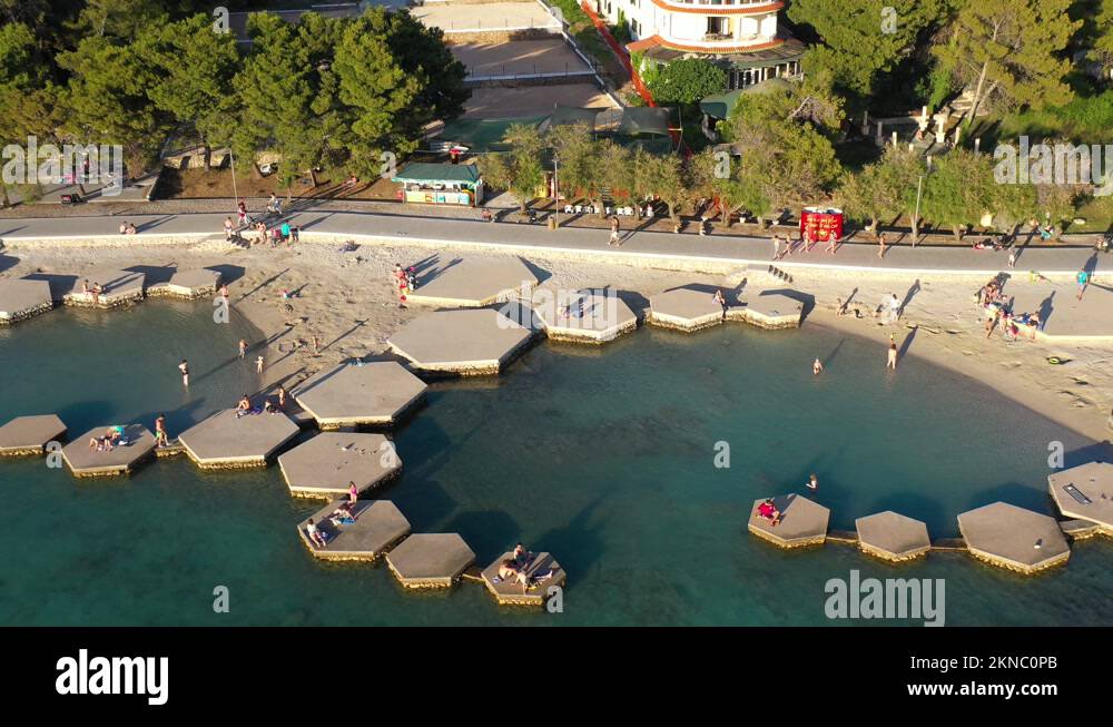People Swimming And Relaxing At Hexagonal Platform At Plava Beach In ...