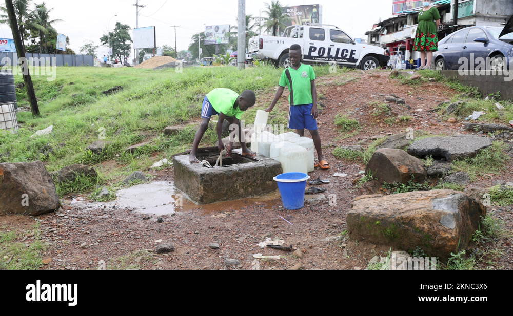 Boys drawing water from public well urban Monrovia Liberia 4K Stock ...