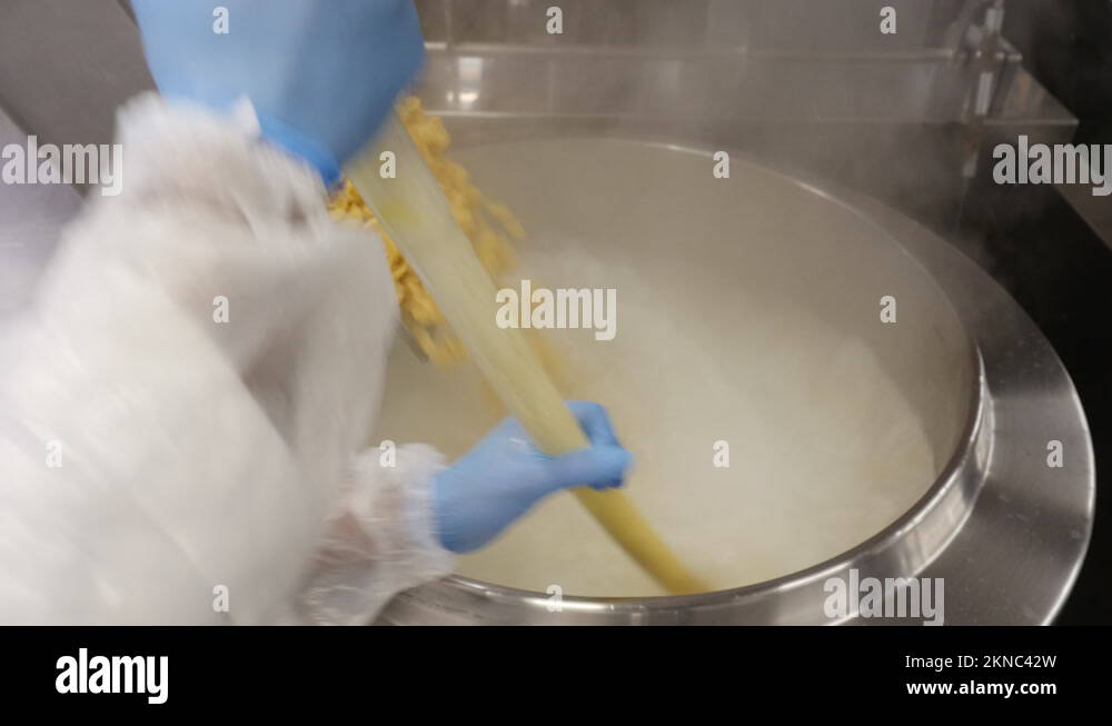 Cooking pasta at a ready-made food factory. Workers at the ready-made ...