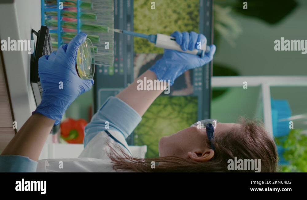 Vertical video: Chemist woman taking dna liquid from test tube with ...