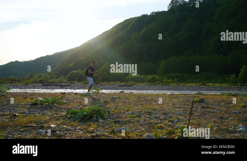 tired man with bionic prosthetic leg is walking alone in nature ...