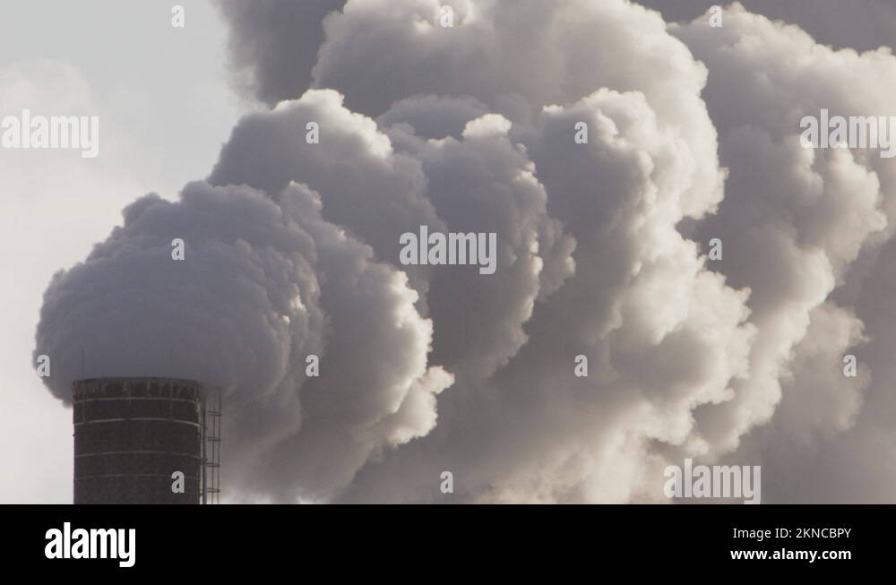 EPIC ZOOM OUT to thick billowing smoke from an industrial chimney Stock ...