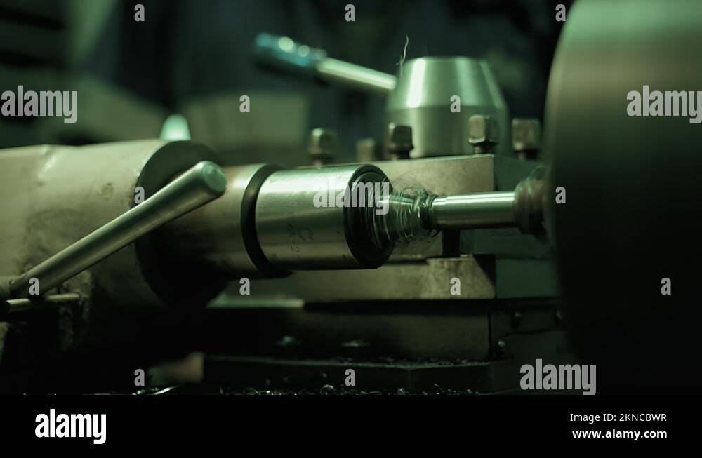Processing of metal parts and workpieces on a lathe in a factory ...