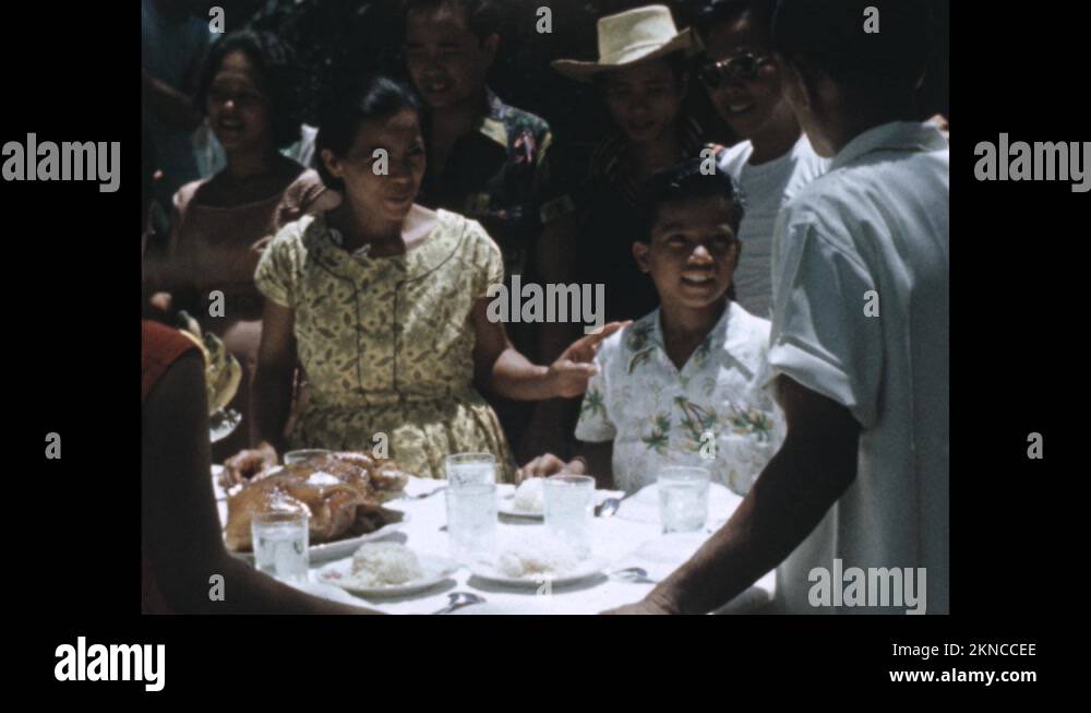1950s: Party. Parents speak and pat boy on shoulder. Shooting slate ...