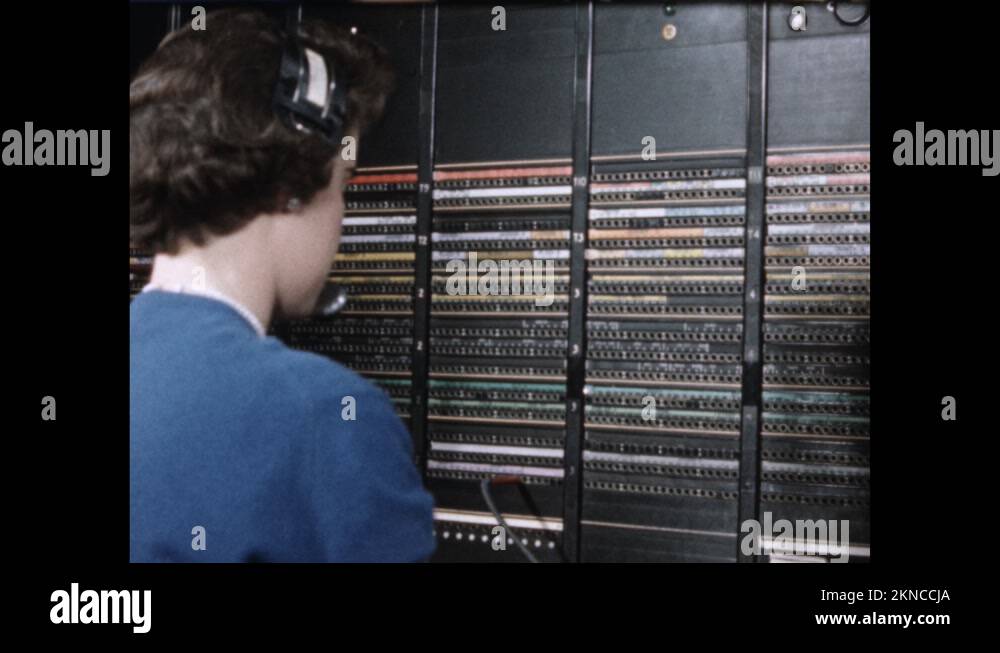 1950s: Telephone operators at switchboard. Black and white photo in ...