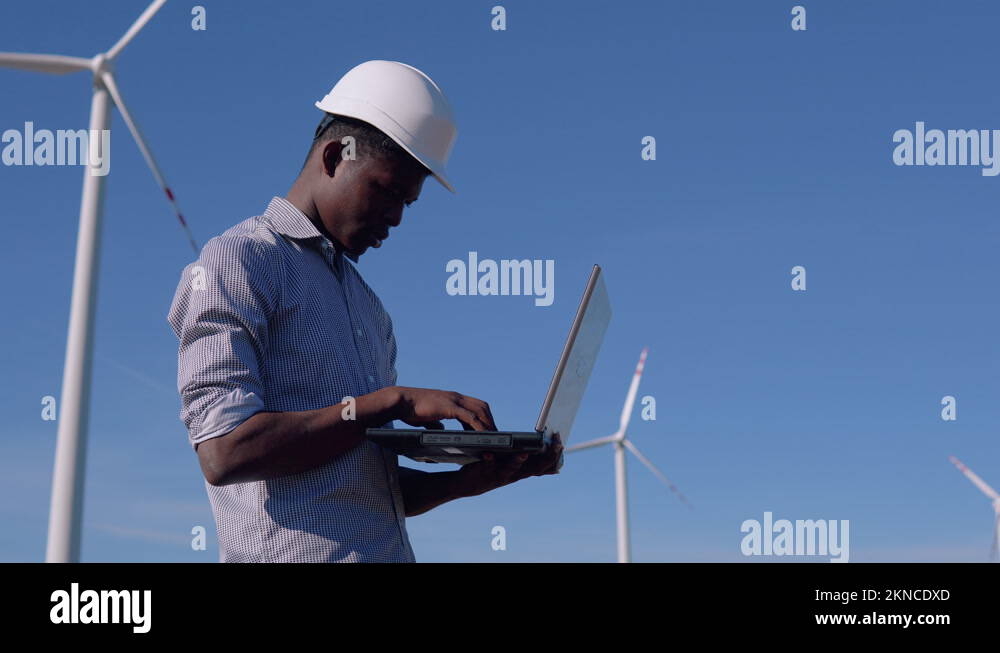An African American electrical engineer is standing against the ...