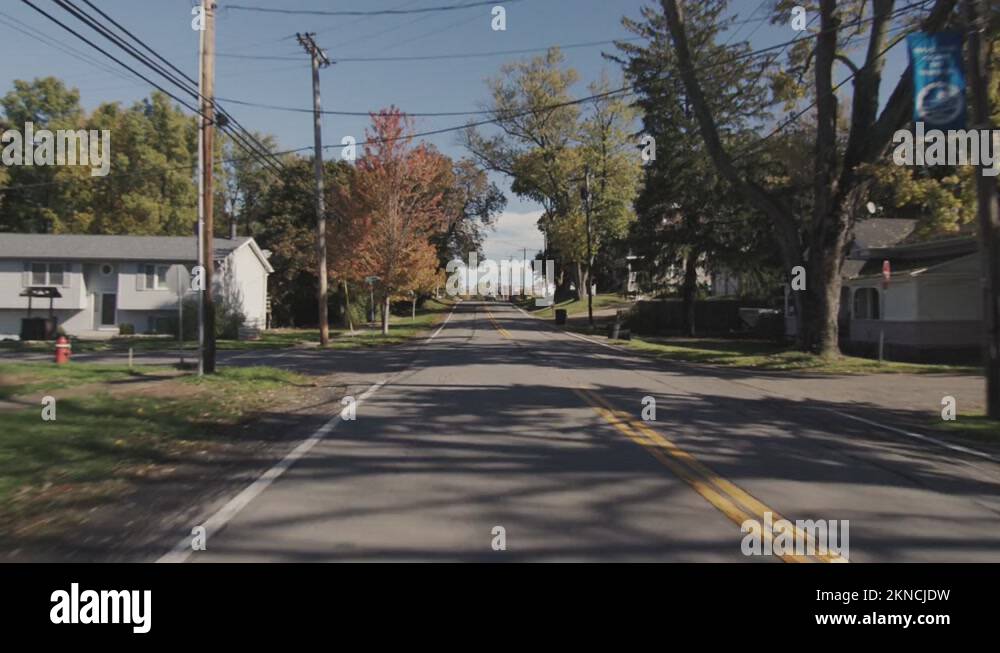 Drive through a typical American suburb as seen from the rear window of ...