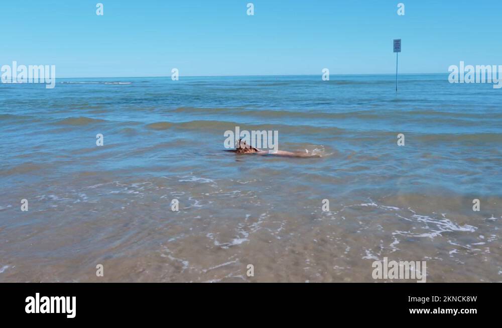 Dead human body swimming on water surface in shallow, person in water ...