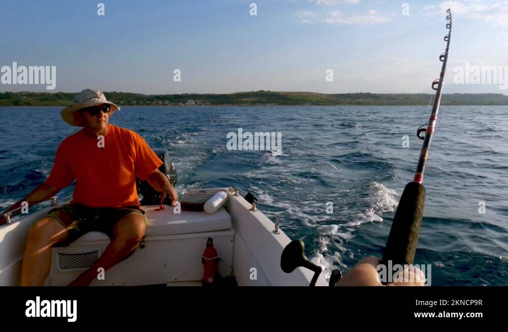 First-person pov of man fishing with rod and another fisherman trolling ...