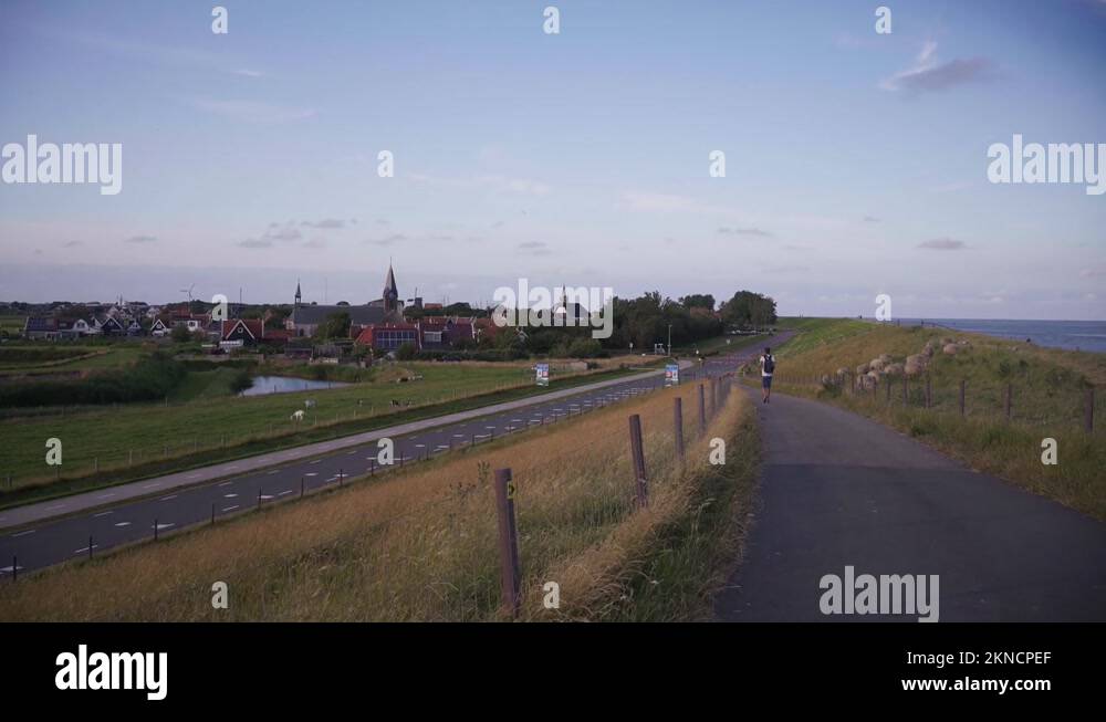 Handheld unstable shaky footage of man walking on highway along the ...