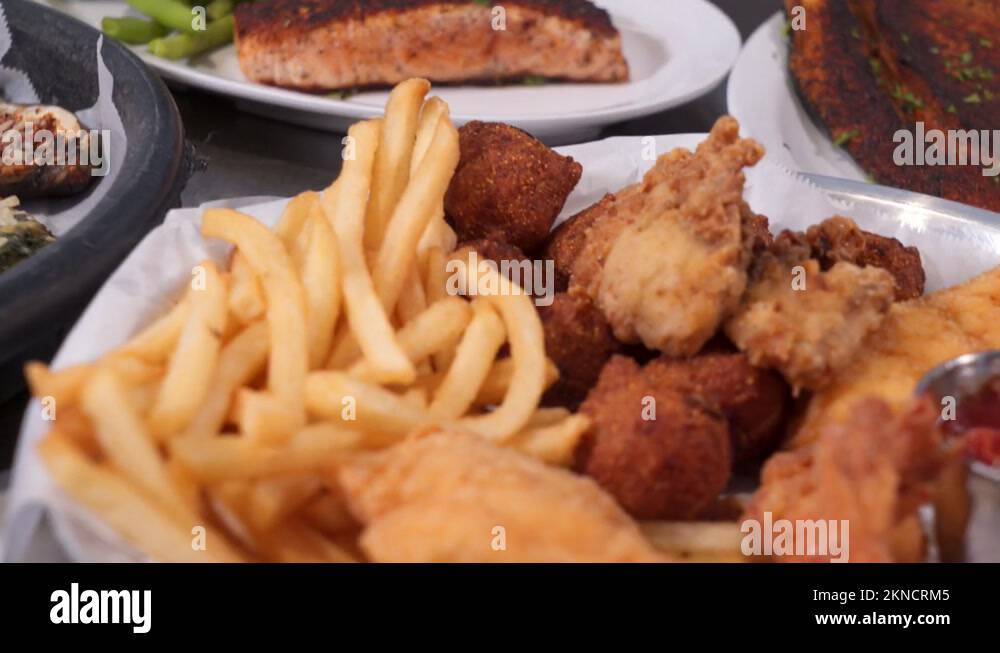 A tempting variety of fried and blackened seafood restaurant plates ...