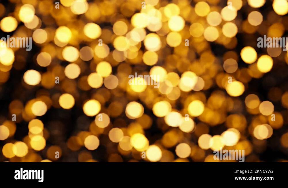 Yellow shining light particles bokeh rendered as looping motion ...