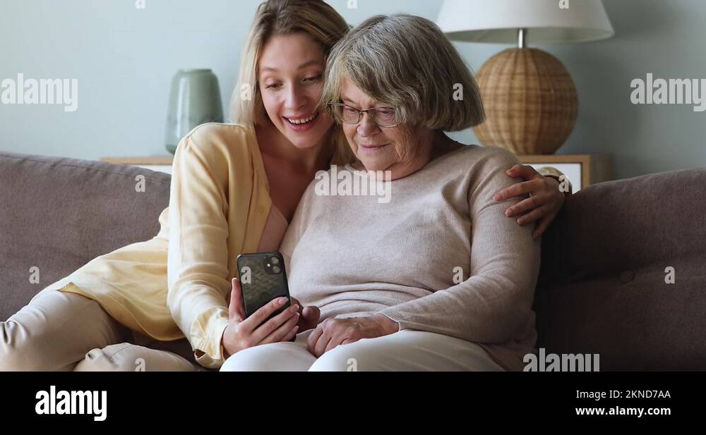 Caring Adult Granddaughter Teach Older Grandma To Use Modern Phone