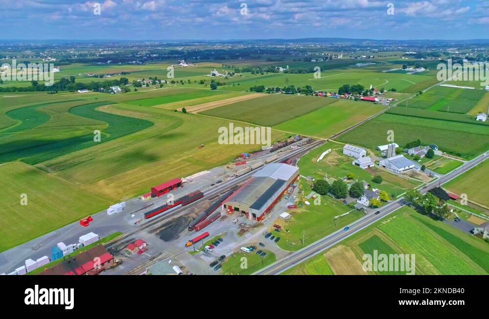 An Aerial Traveling View of Corn Fields and Harvesting Crops, With a ...