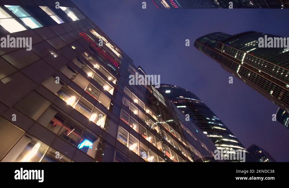 Night view from the bottom up of the skyscrapers and towers of downtown ...