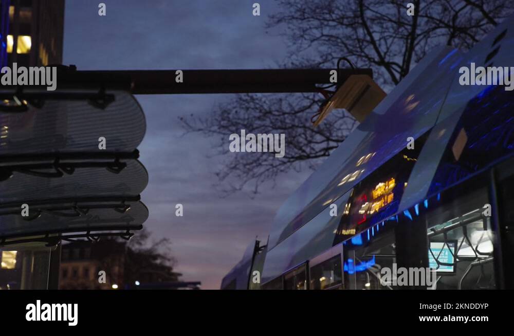 Electric bus departs after charging at the bus station - cinematic shot ...