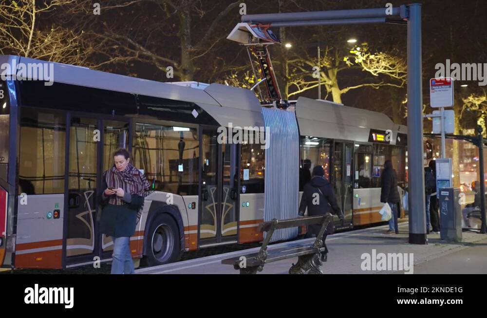 Pantograph for electric bus charging at the bus stop in the evening ...