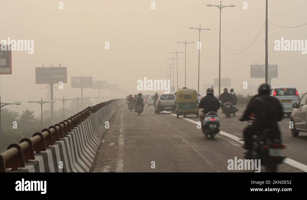 A view of traffic moving on a flyover in the dense smog due to ...