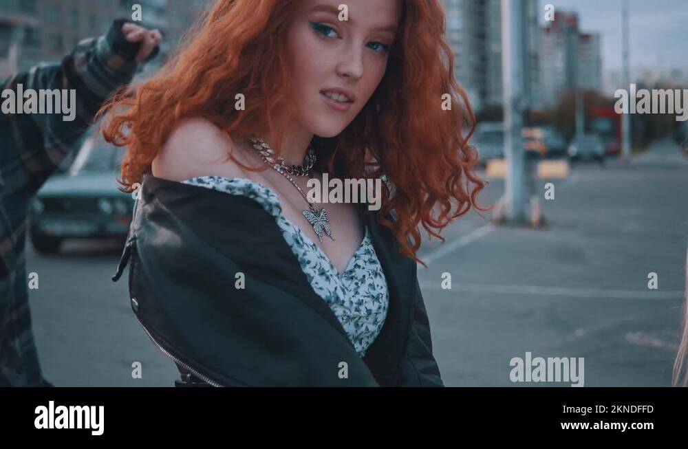 Pretty curly ginger woman shaking into music dancing hanging out with ...
