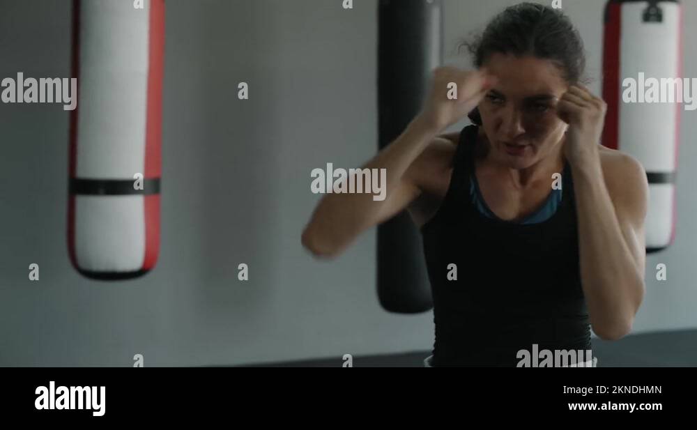 Mixed martial art fighter woman does shadow boxing in the fight club ...