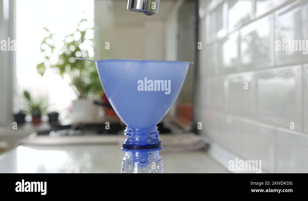 Filling a Plastic Bottle Drop by Drop with Fresh Water Using a Funnel ...