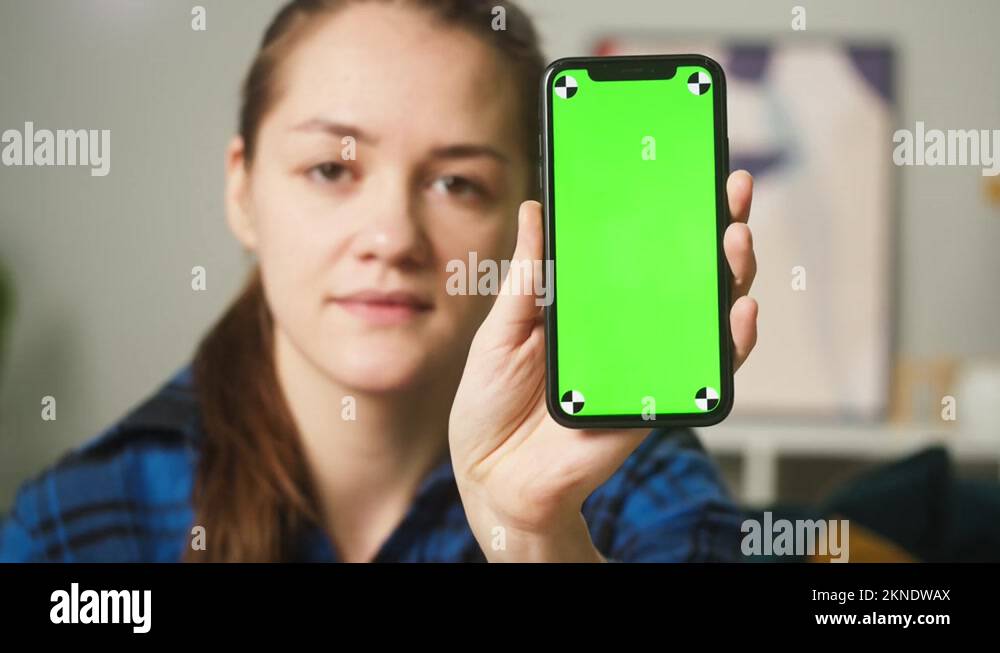 Woman showing phone with chroma green screen, vaccination passport with ...