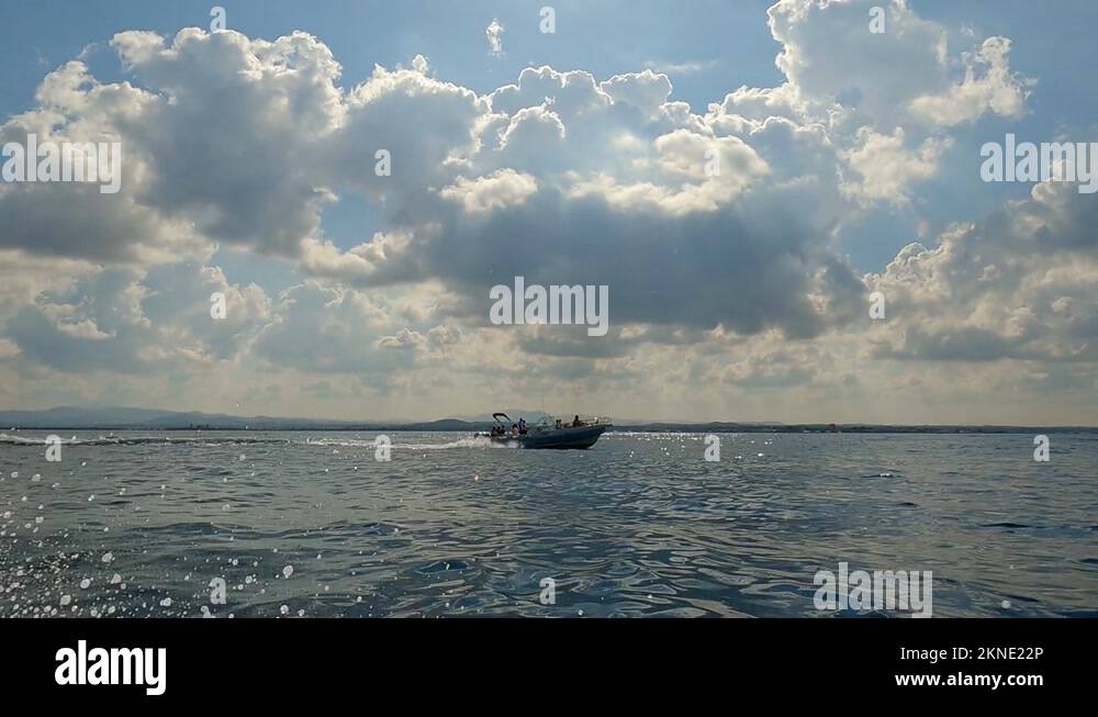 Low-angle sea-level view of motorboat navigating on sea water as seen ...