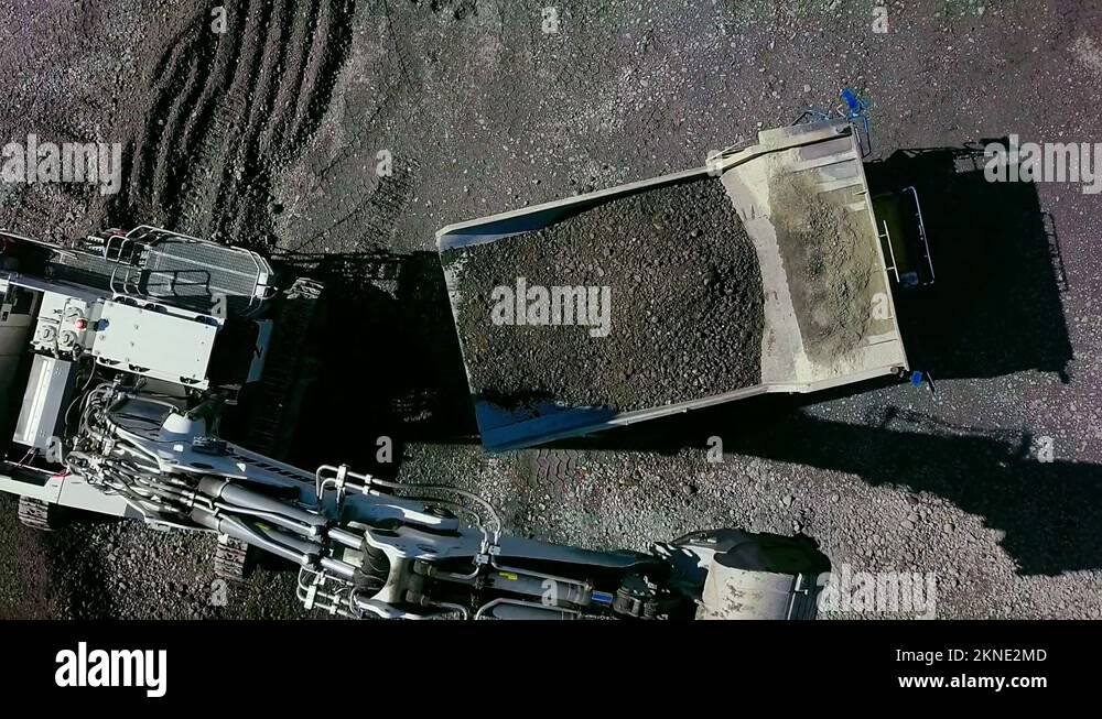 Mining Industry Earthmoving Excavator Drops Dirt In Cargo Box Of Dump ...