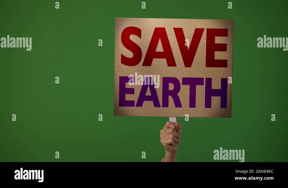 Arm holding a sign that says SAVE EARTH on a green screen chroma key ...